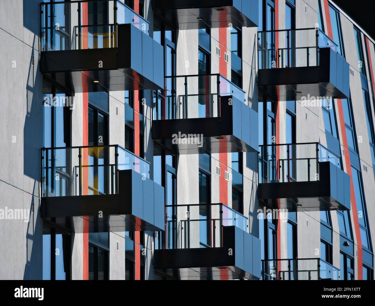 High-rise condominiums complex facade with white, red and black ...