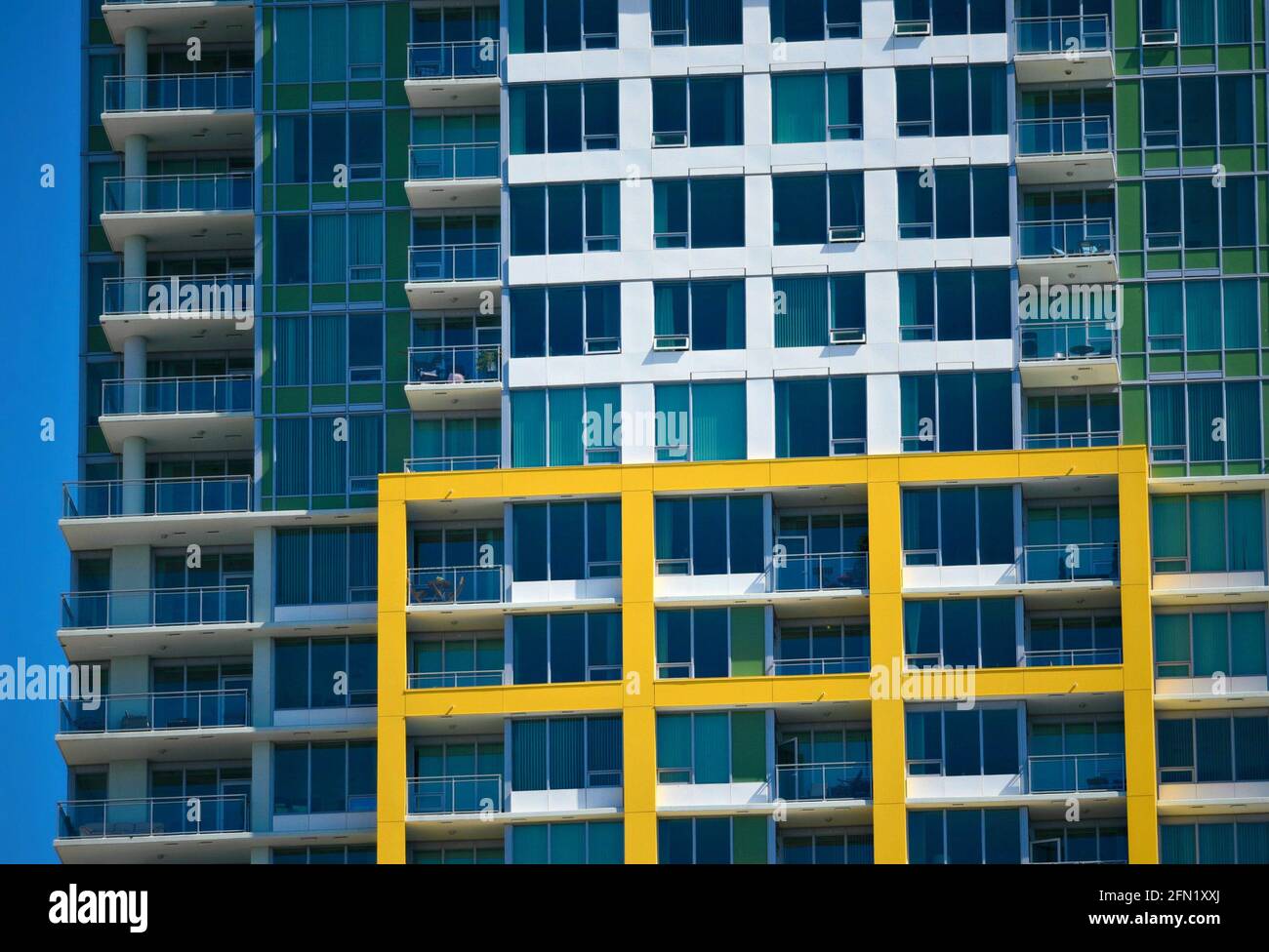 Residential high-rise condominiums complex facade with white and yellow ...