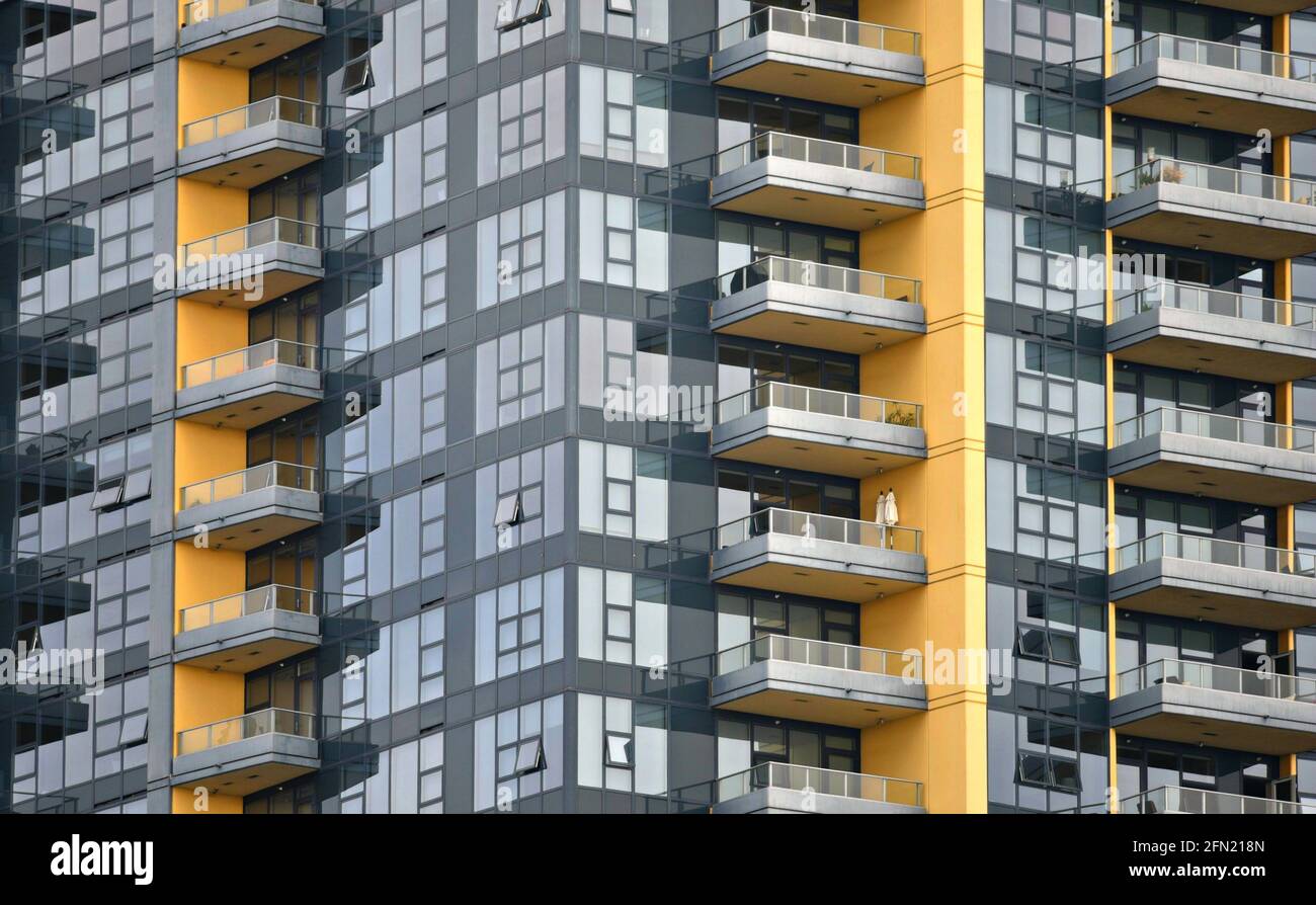 Residential condominiums complex facade with symmetrical white concrete ...