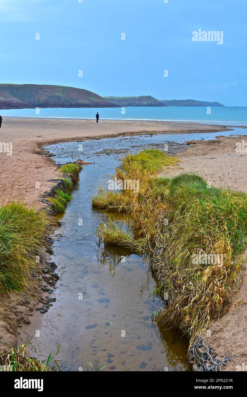 A view of the pretty bay at Freshwater East.Here a small local stream ...