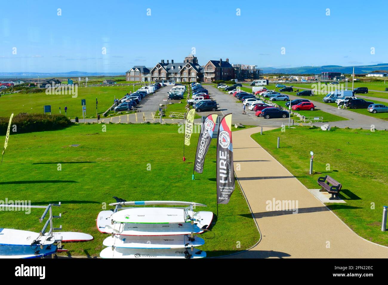 A view across the car park at Rest Bay.Surf boards in foreground ...