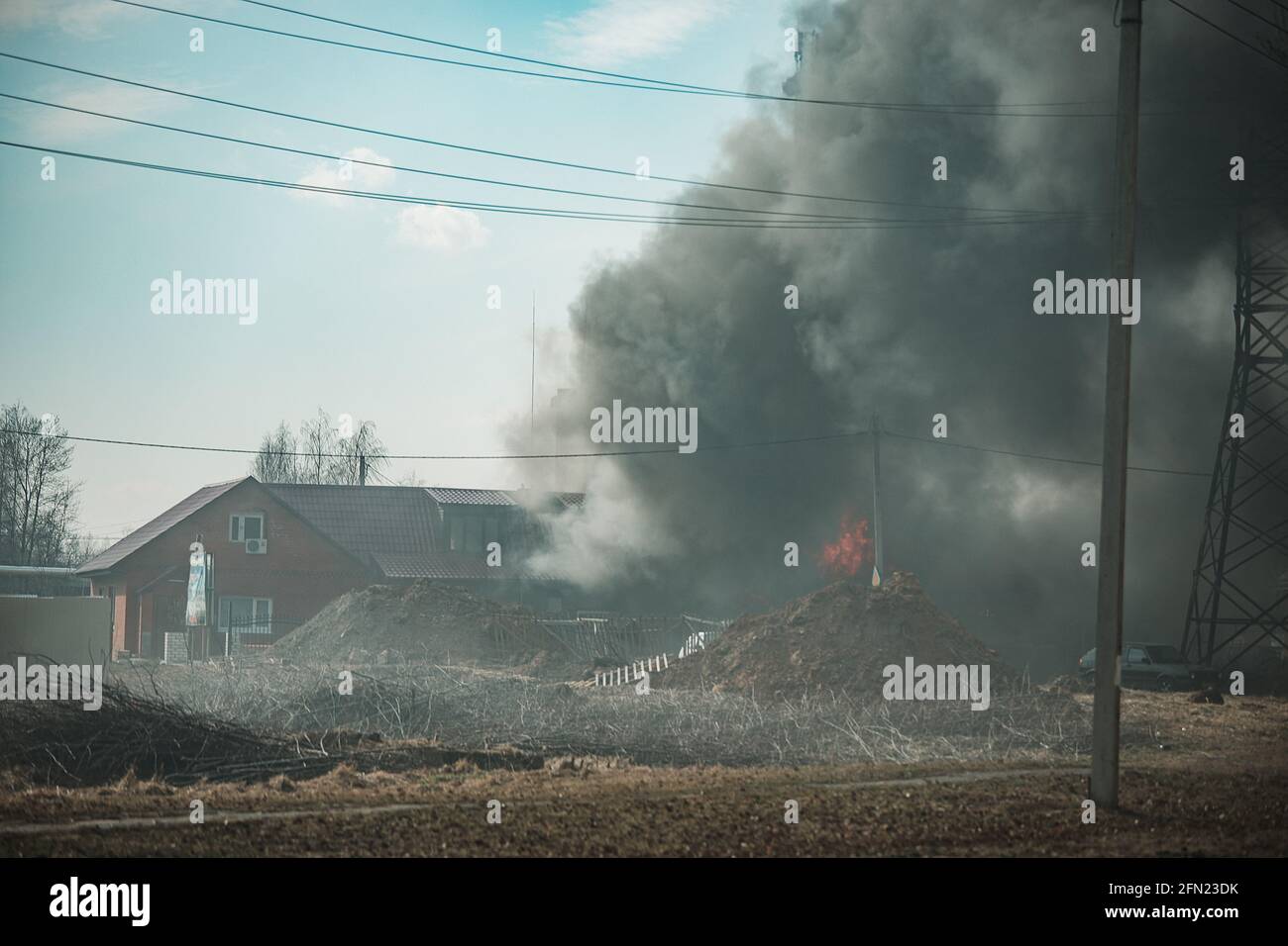 the fire destroys the building. the fire brigade pours water on the ...