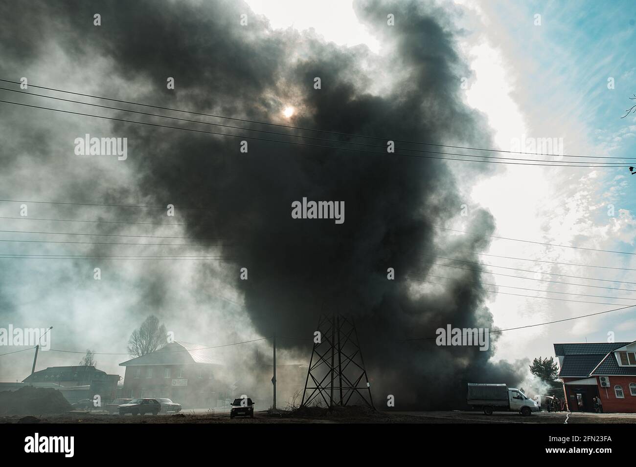 the fire destroys the building. the fire brigade pours water on the ...