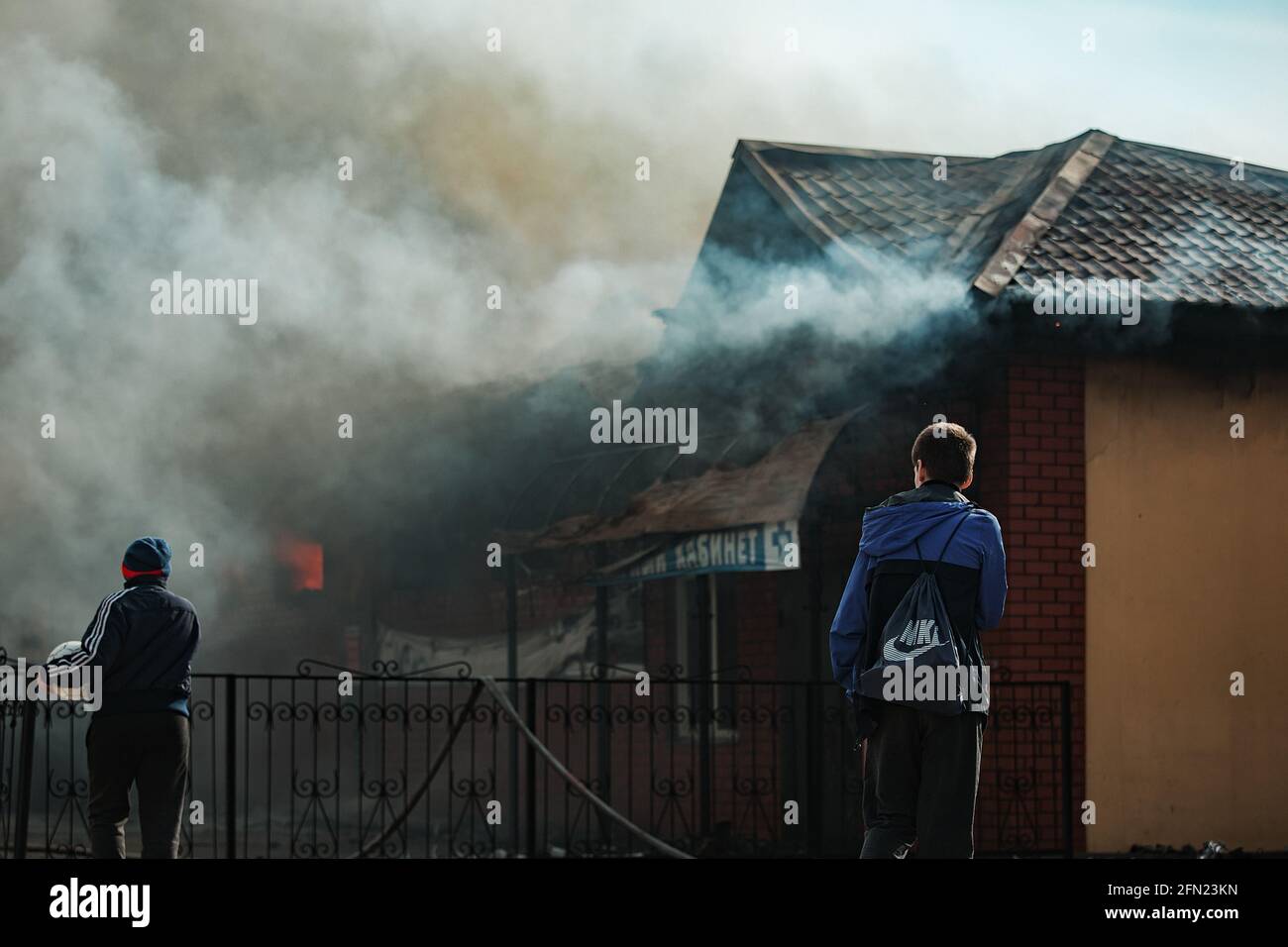 the fire destroys the building. the fire brigade pours water on the ...