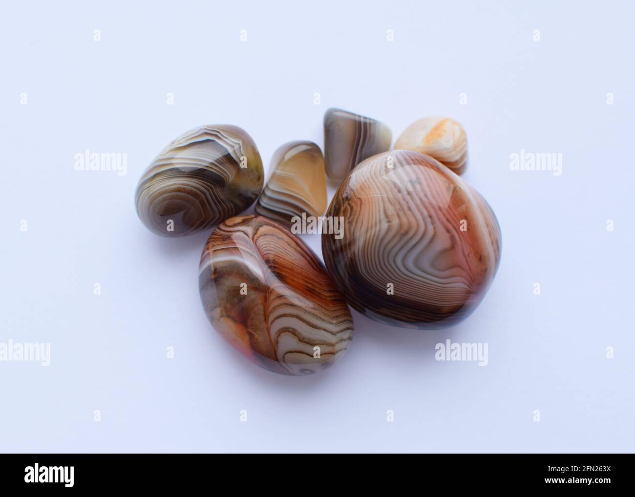 Multicolored gemstones, tumbled minerals. Agates of various sizes ...