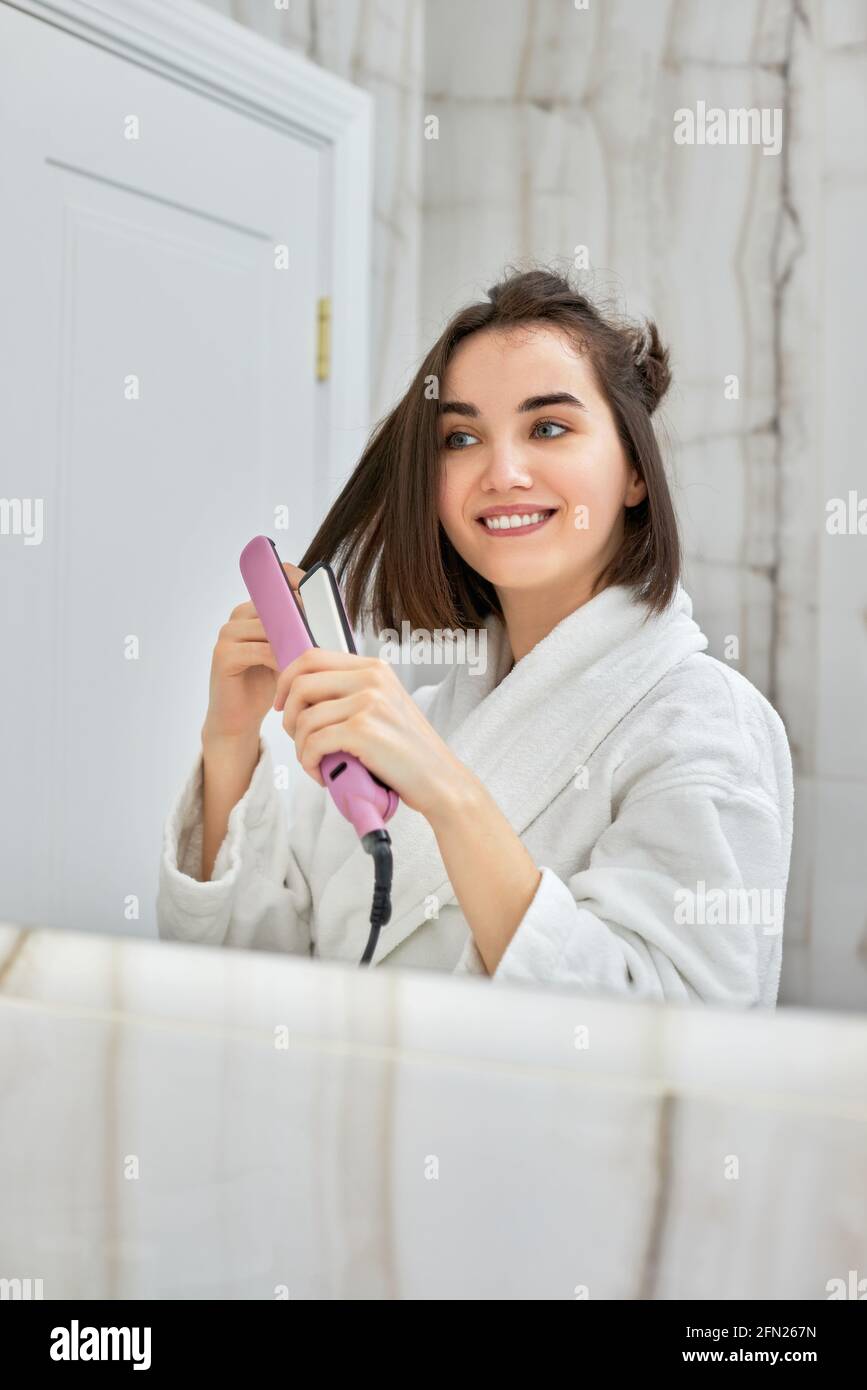 Straightening hair hi-res stock photography and images - Alamy