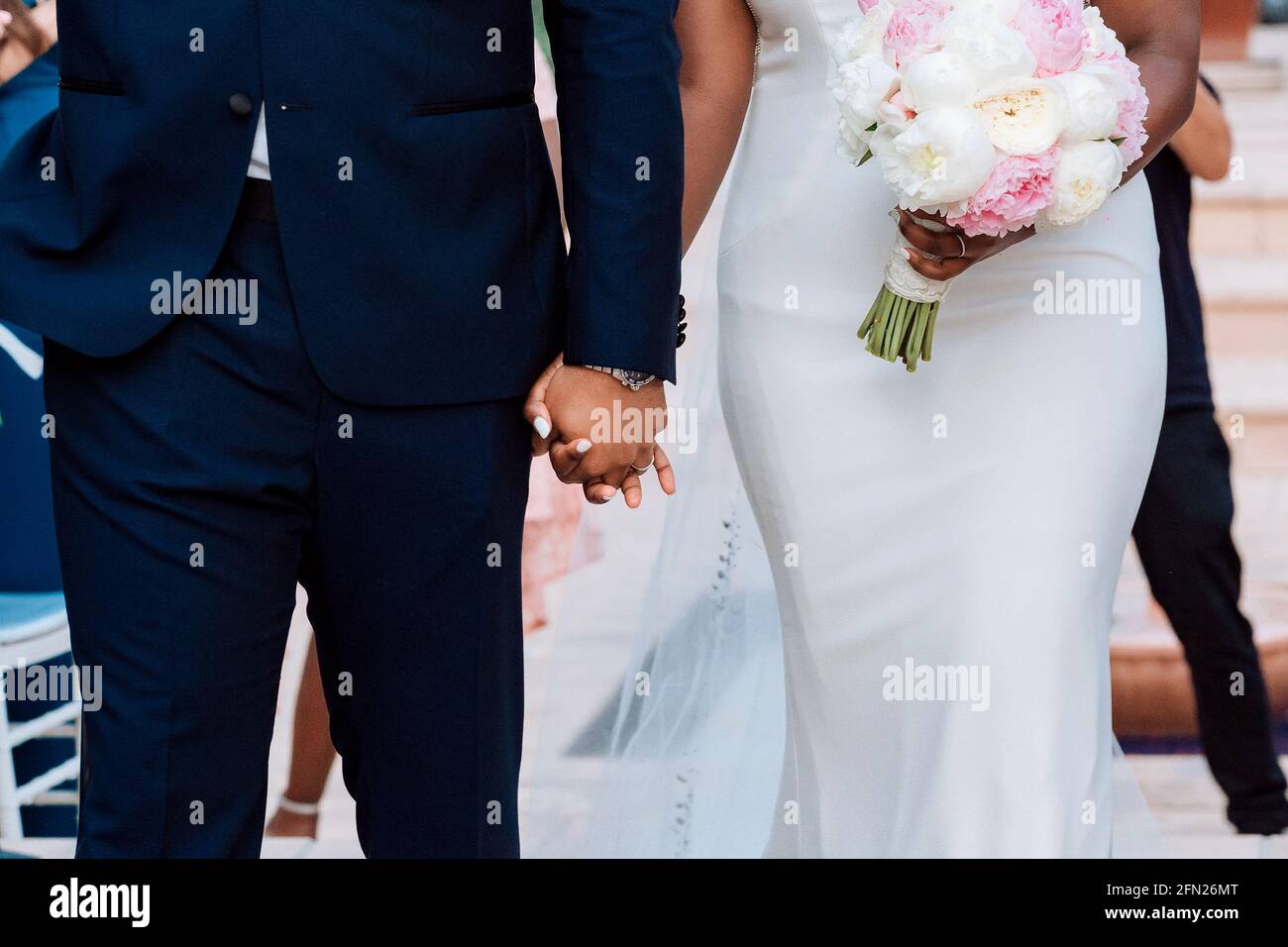 The groom holds his bride by the hand. Hands close up Stock Photo - Alamy