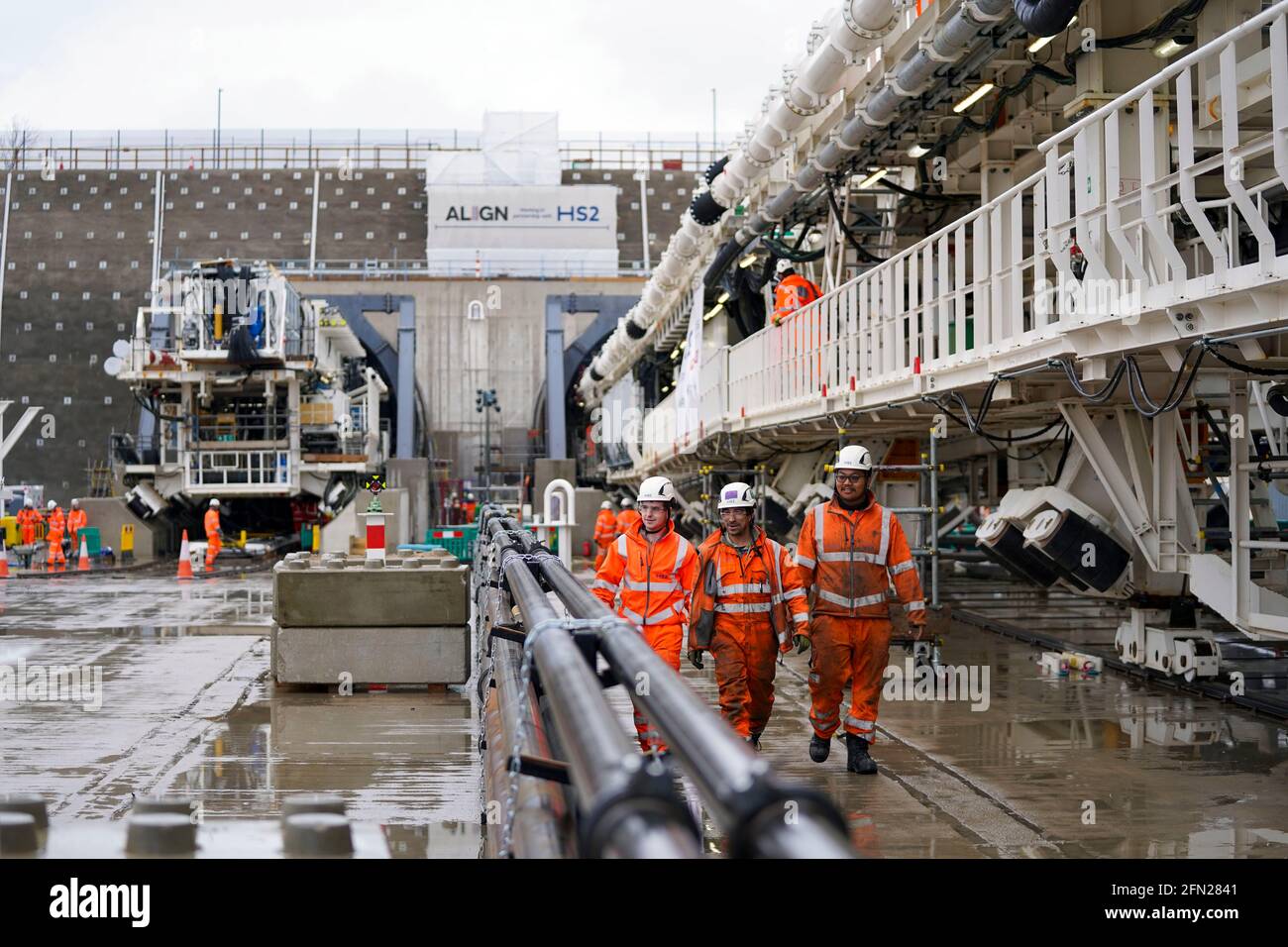 Workers walk next to Florence - the largest ever tunnel boring machine ...