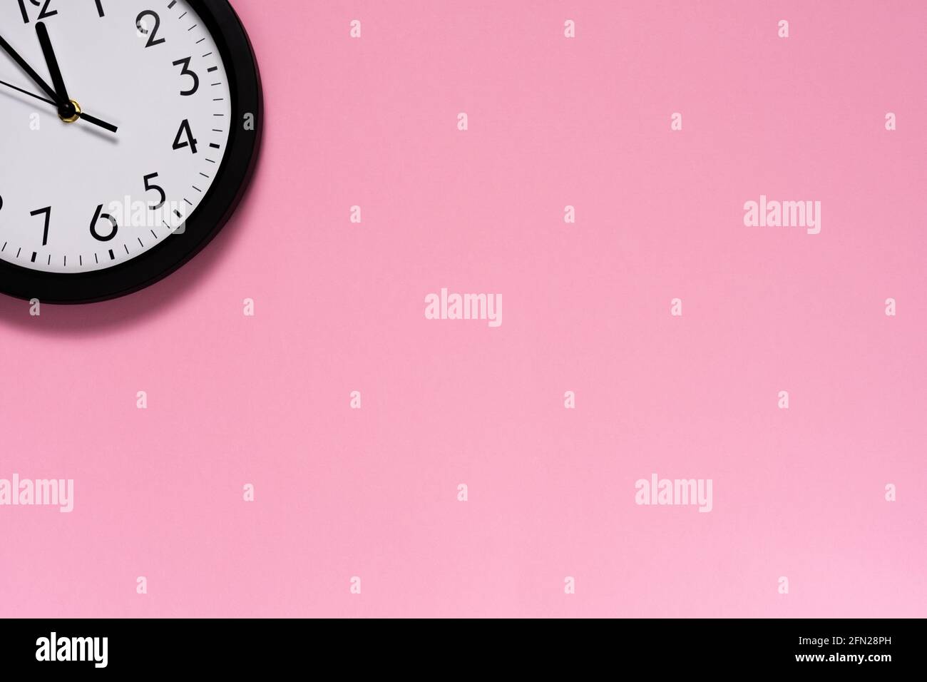 an analog clock on a pink background Stock Photo - Alamy