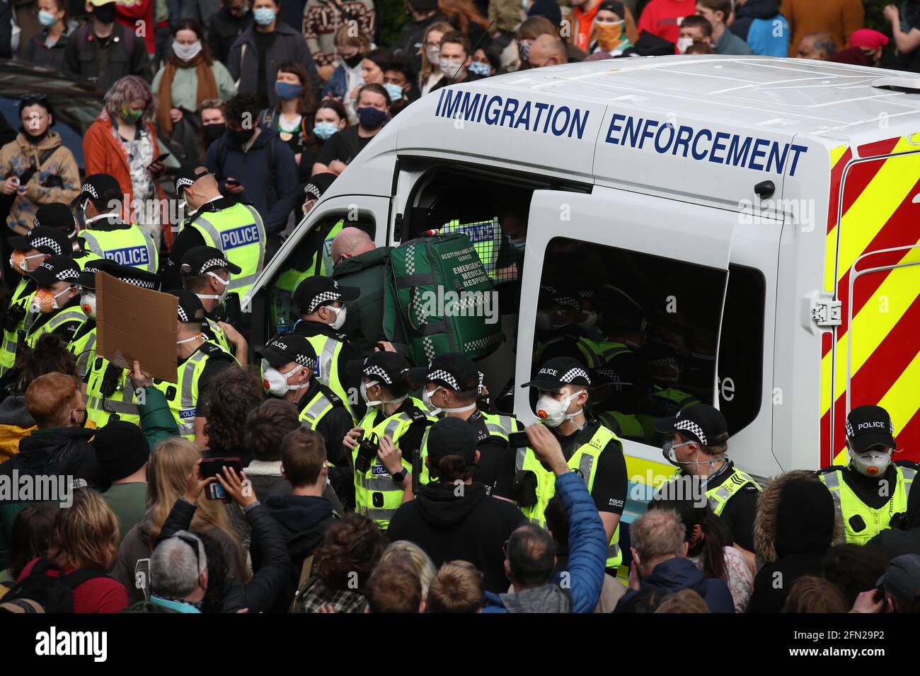 Police by an immigration van in Kenmure Street, Glasgow which is ...