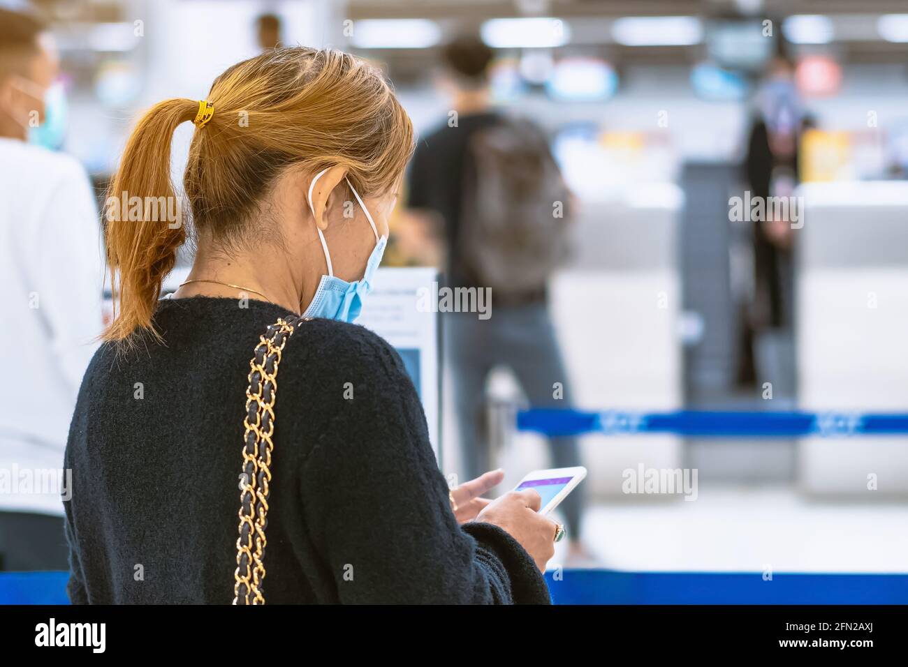 Back view of airline passenger wear face mask to prevent Corona virus ...
