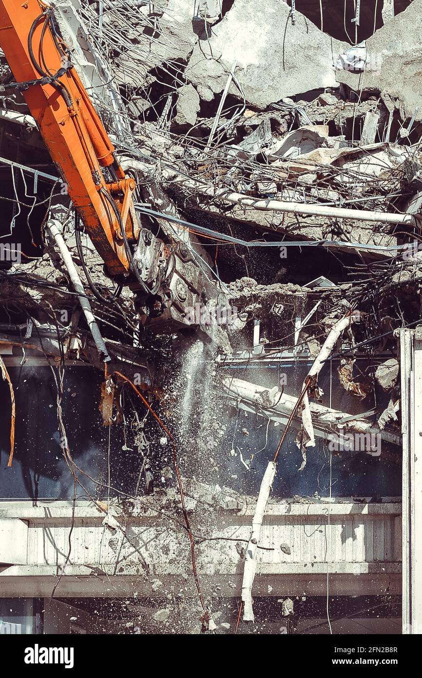 Shot of demolition and destruction of a building by excavator Stock ...