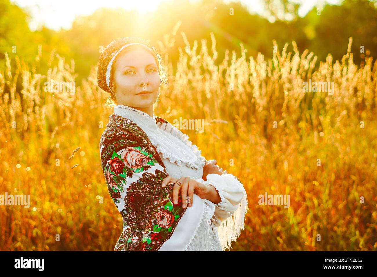 Young beautiful slovak woman in traditional costume on summer daisy ...