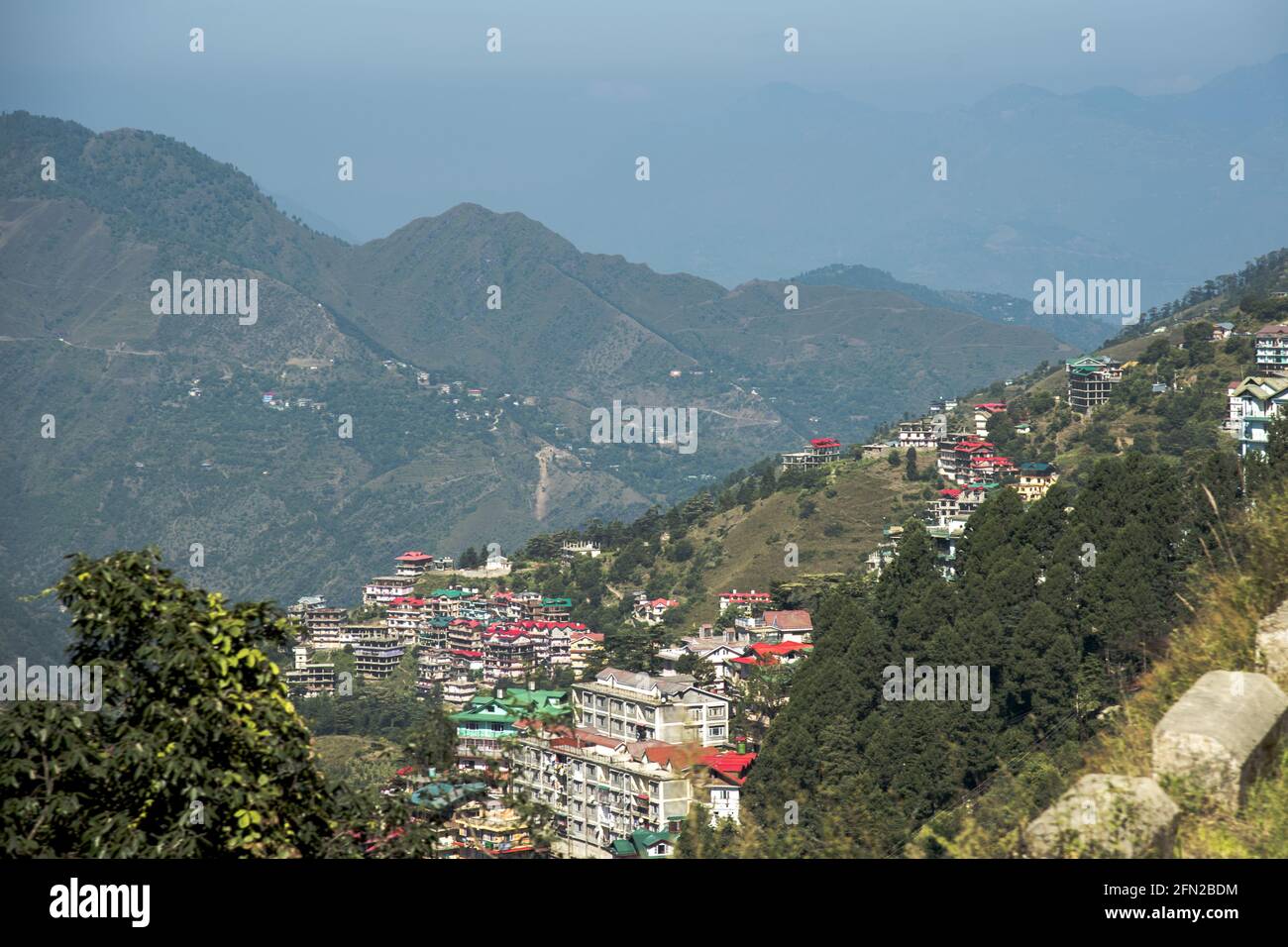 Vast landscape with green hills under a misty blue sky and old ...