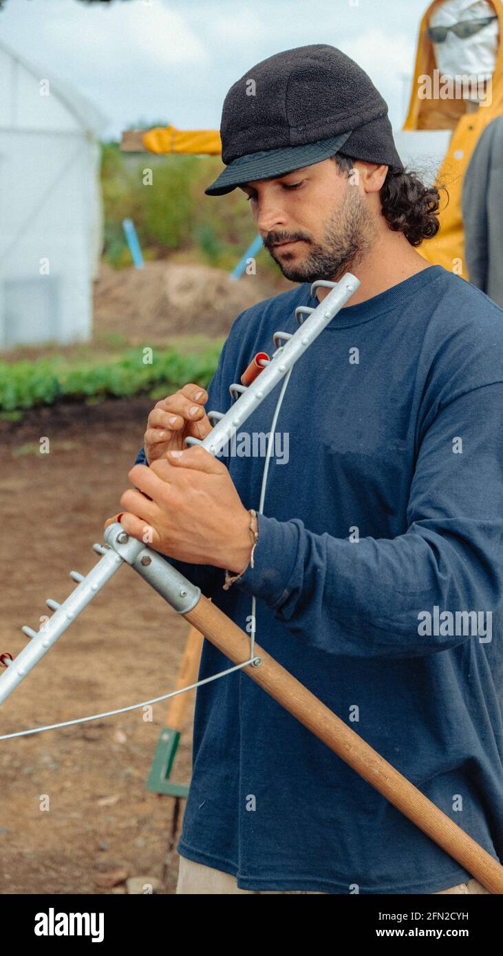 young man farmer, gardener, portrait with his rake preparing him for ...