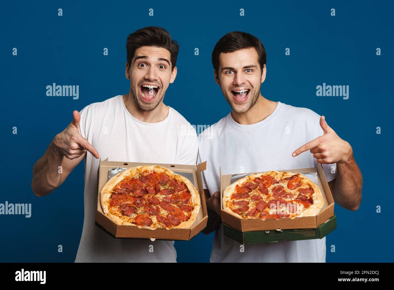Excited handsome guys showing hi-res stock photography and images - Alamy