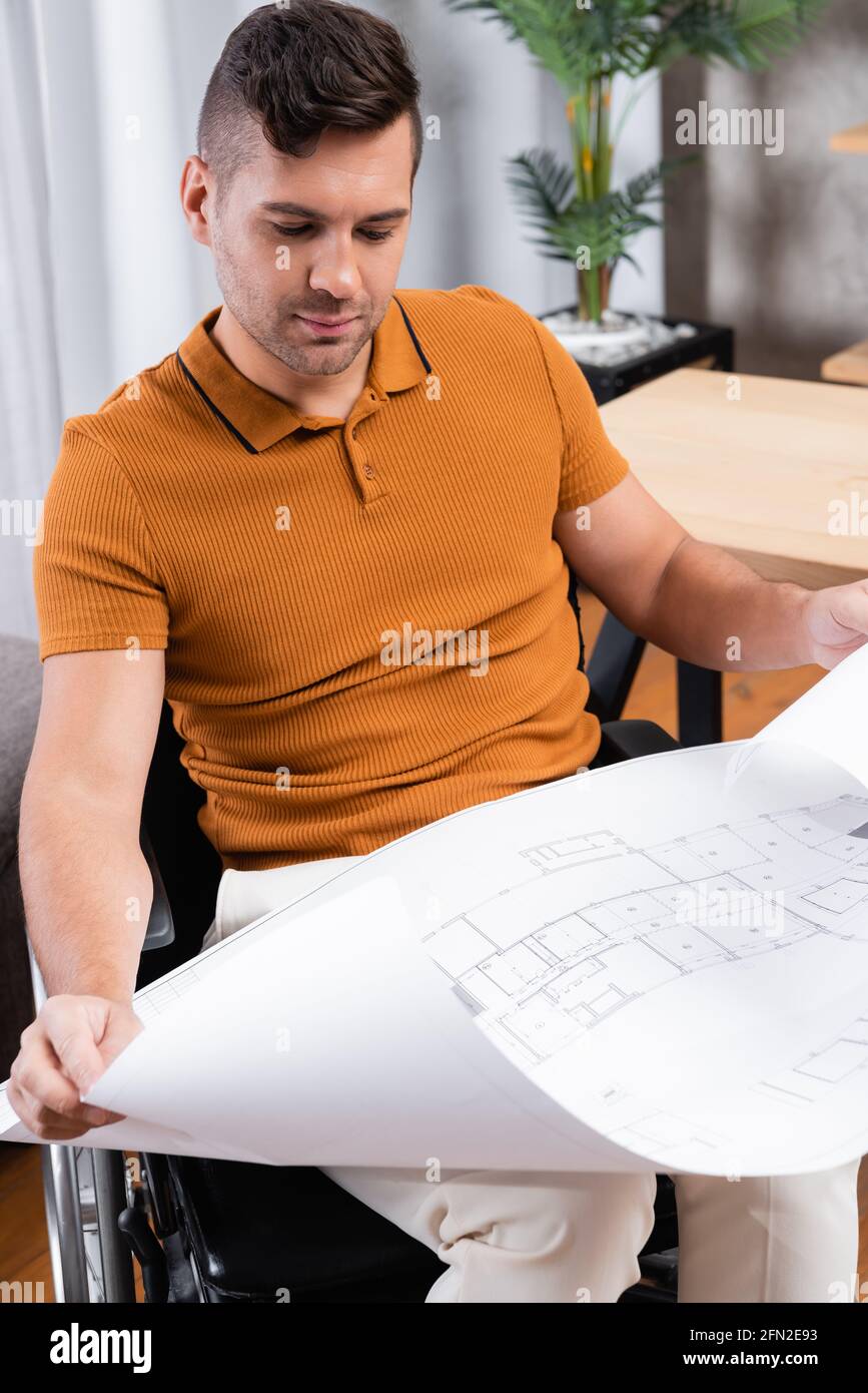 disabled engineer looking at blueprint while working at home Stock ...