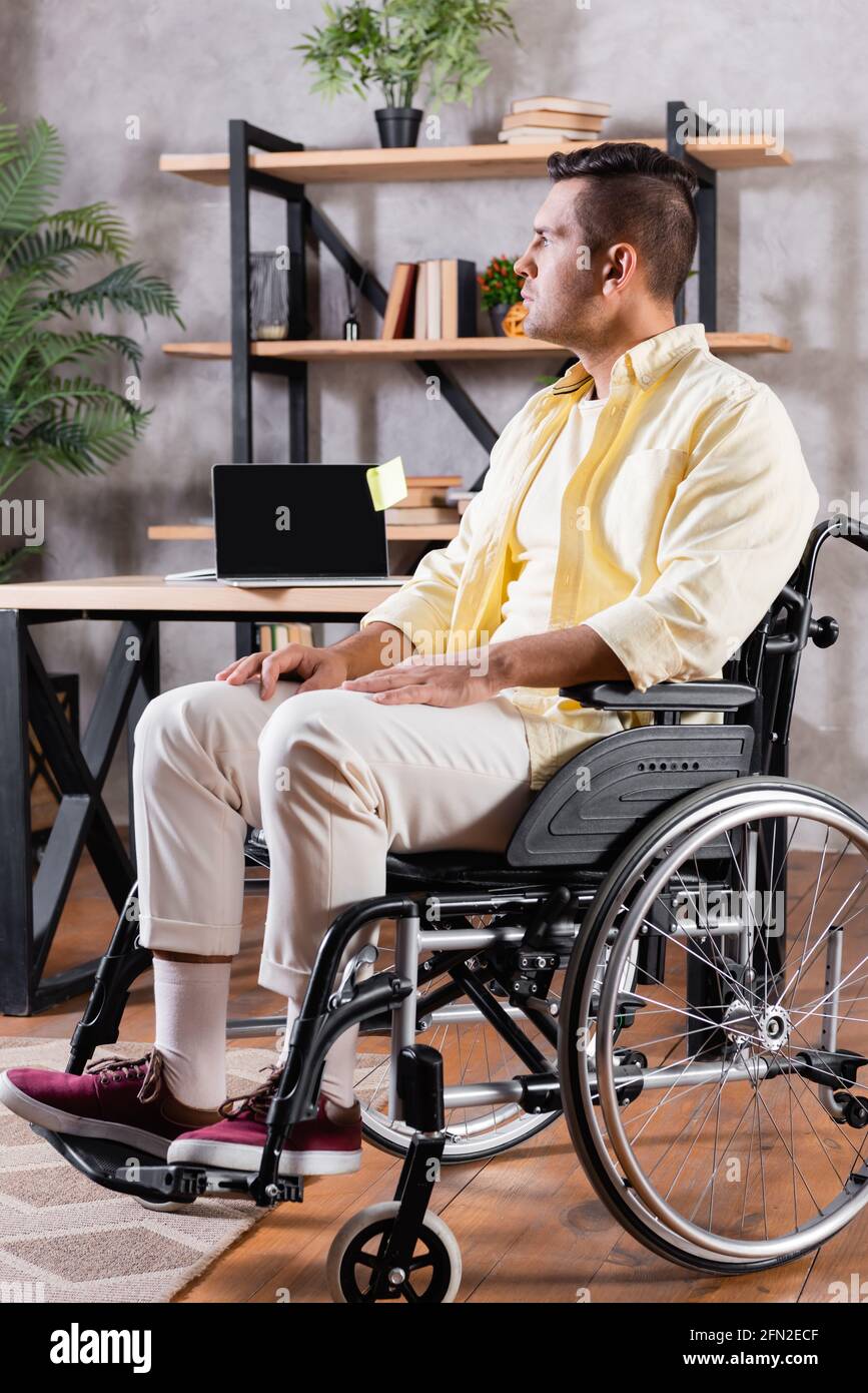 Man sitting desk in wheelchair hi-res stock photography and images - Alamy