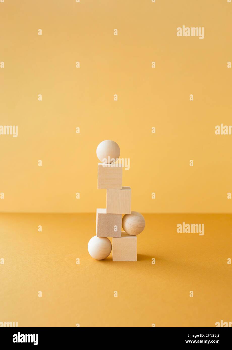 Wooden geometrical figures still life composition. Stack of solids ...