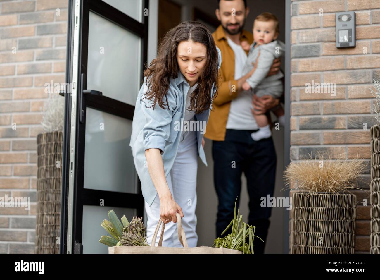 Young parents with newborn kid customer order food delivery online and ...