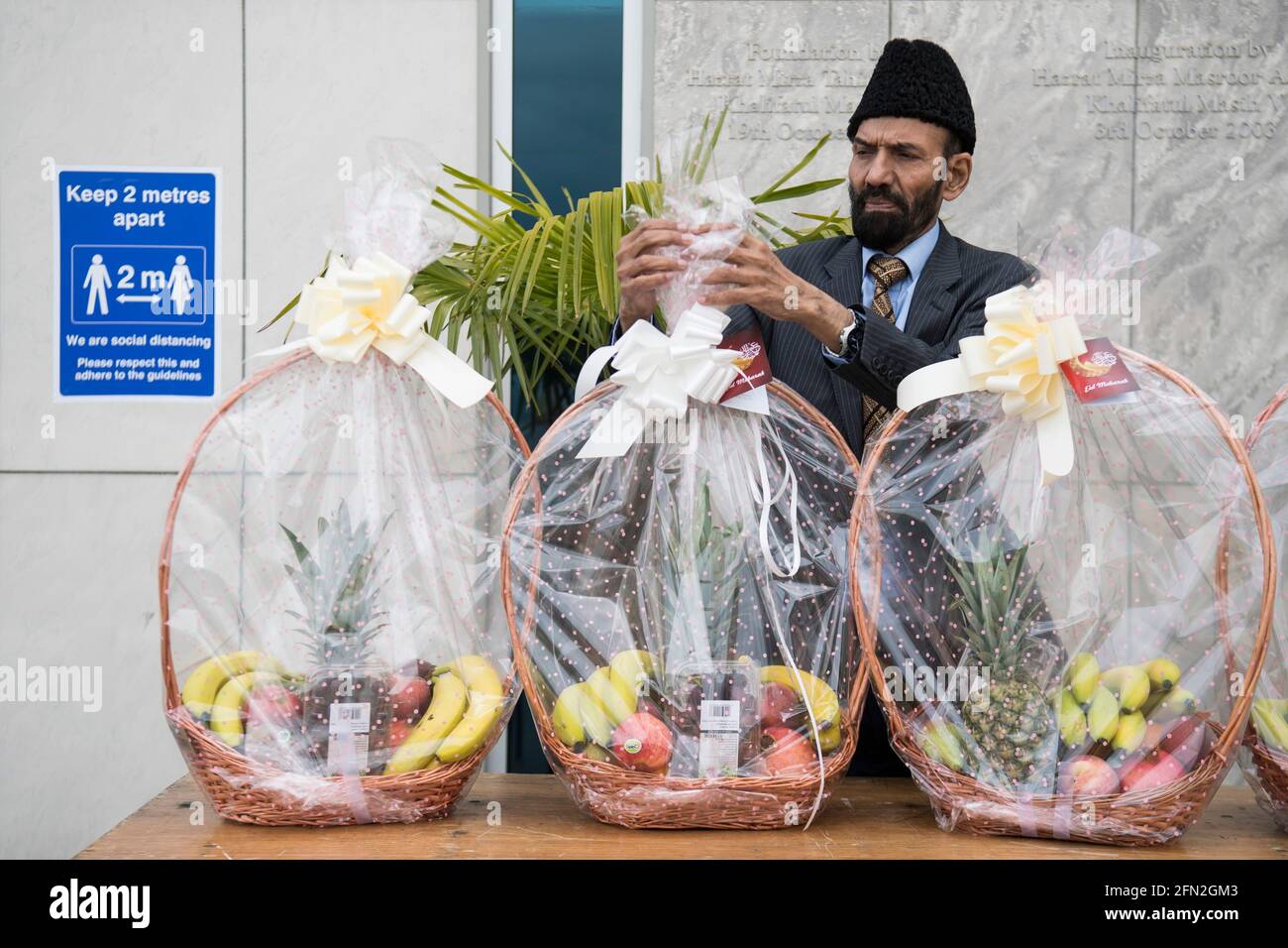 A volunteer prepares to give out fruit baskets to worshippers at the ...