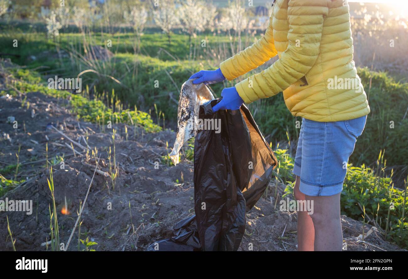 volunteer collecting plastic garbage Earth day Stock Photo - Alamy
