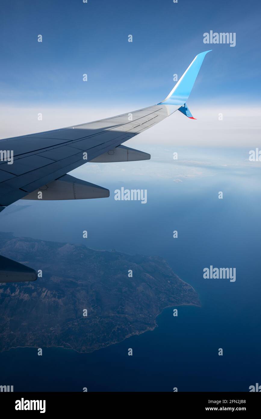 Commercial airplane flying over the Greek Islands of the Mediterranean ...
