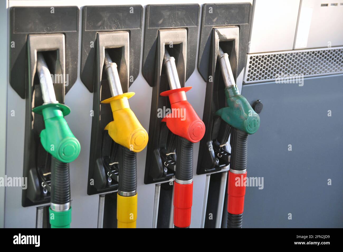 Fuel dispenser at a gas station. Hoses with dispensing guns for ...
