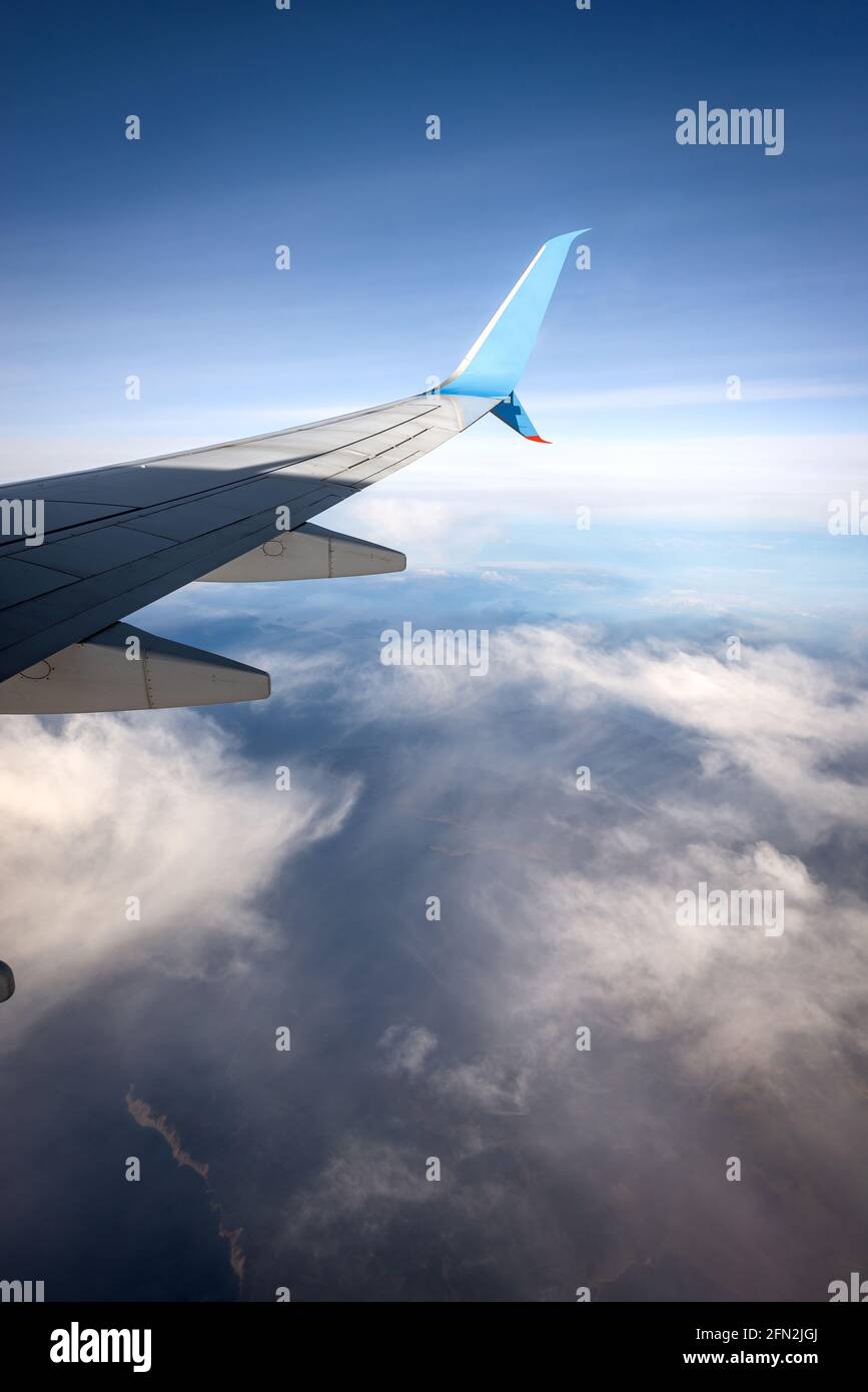Airplane flying over the clouds and the Greek islands of the ...