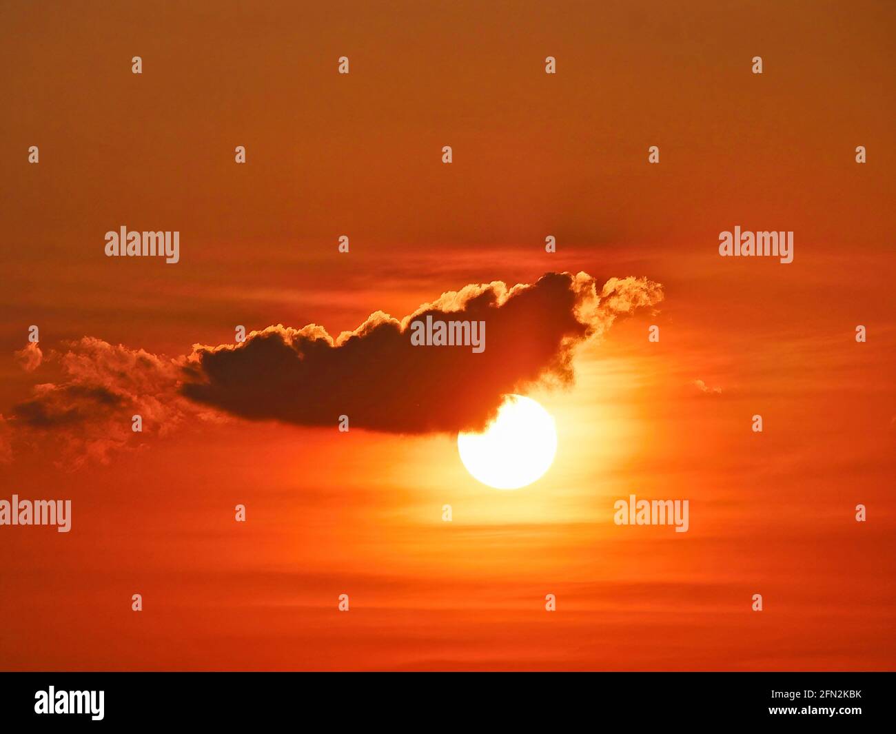 The evening sun in the sky and clouds Stock Photo - Alamy