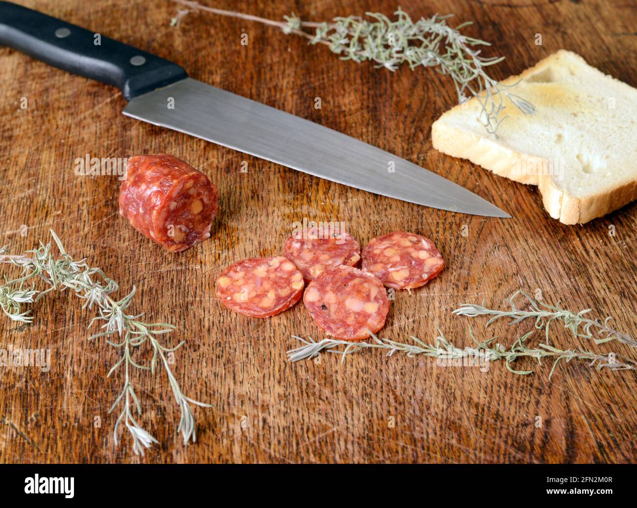 Table with knife and salami toast Stock Photo - Alamy