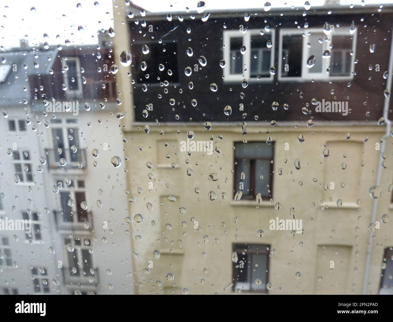 View of houses through a window on a rainy day Stock Photo - Alamy