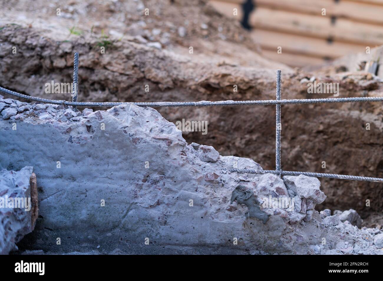 Collapsed concrete structure with protruding reinforcement close-up ...