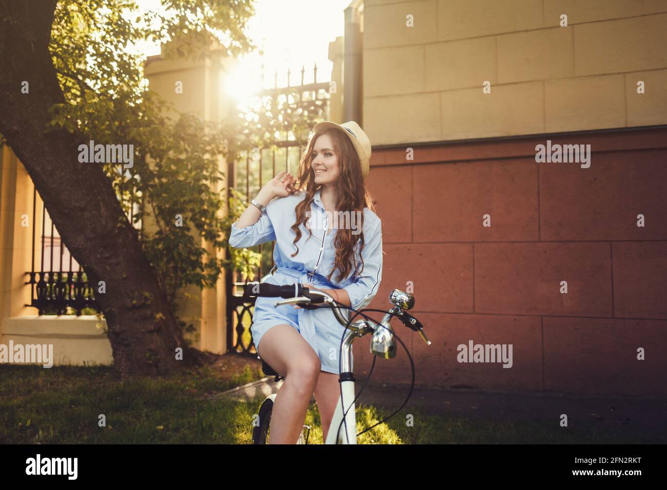 Beautiful woman riding on bike in summer time Stock Photo - Alamy