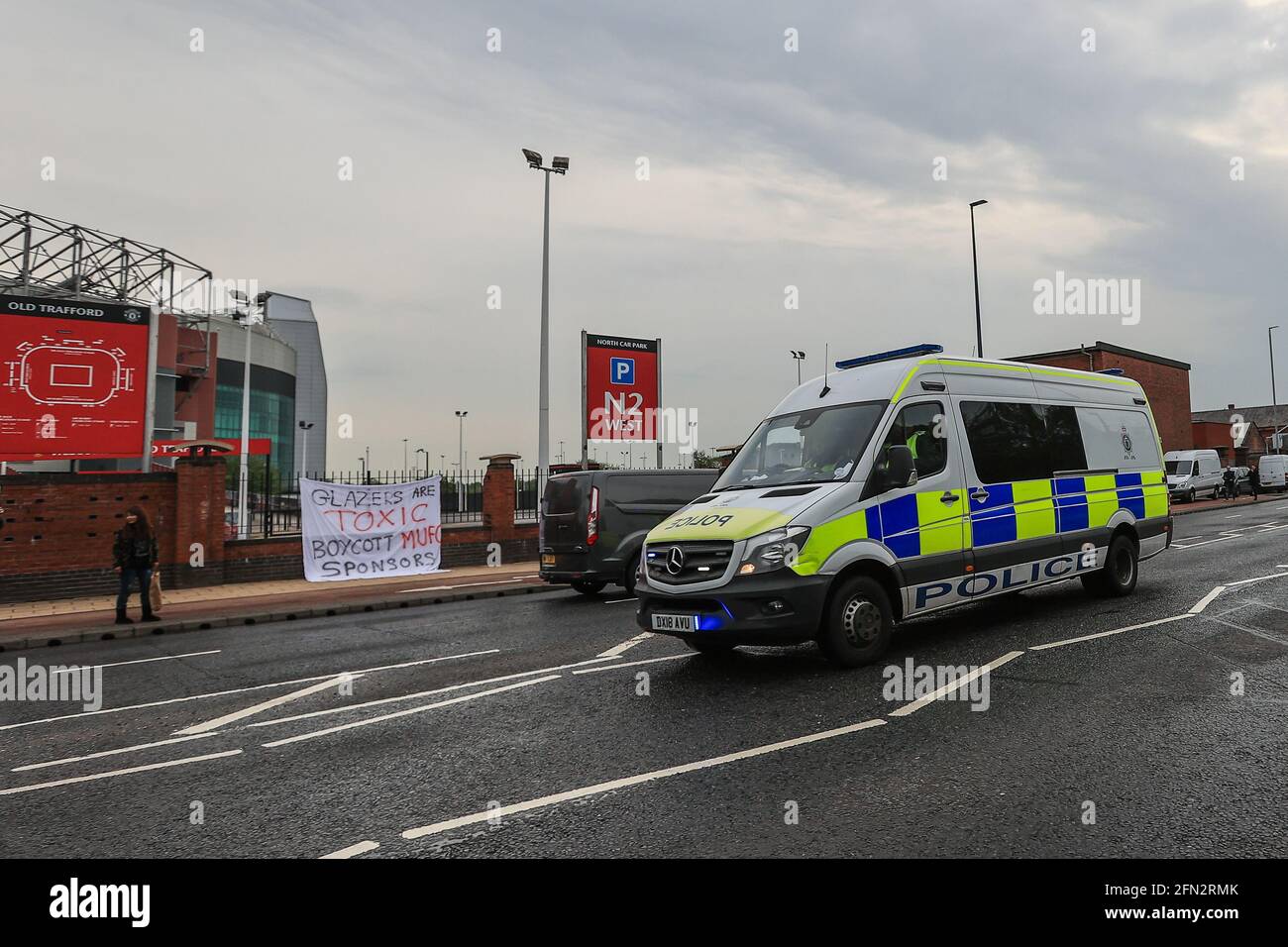 Police vans pass Old Trafford with blue lights on Stock Photo - Alamy