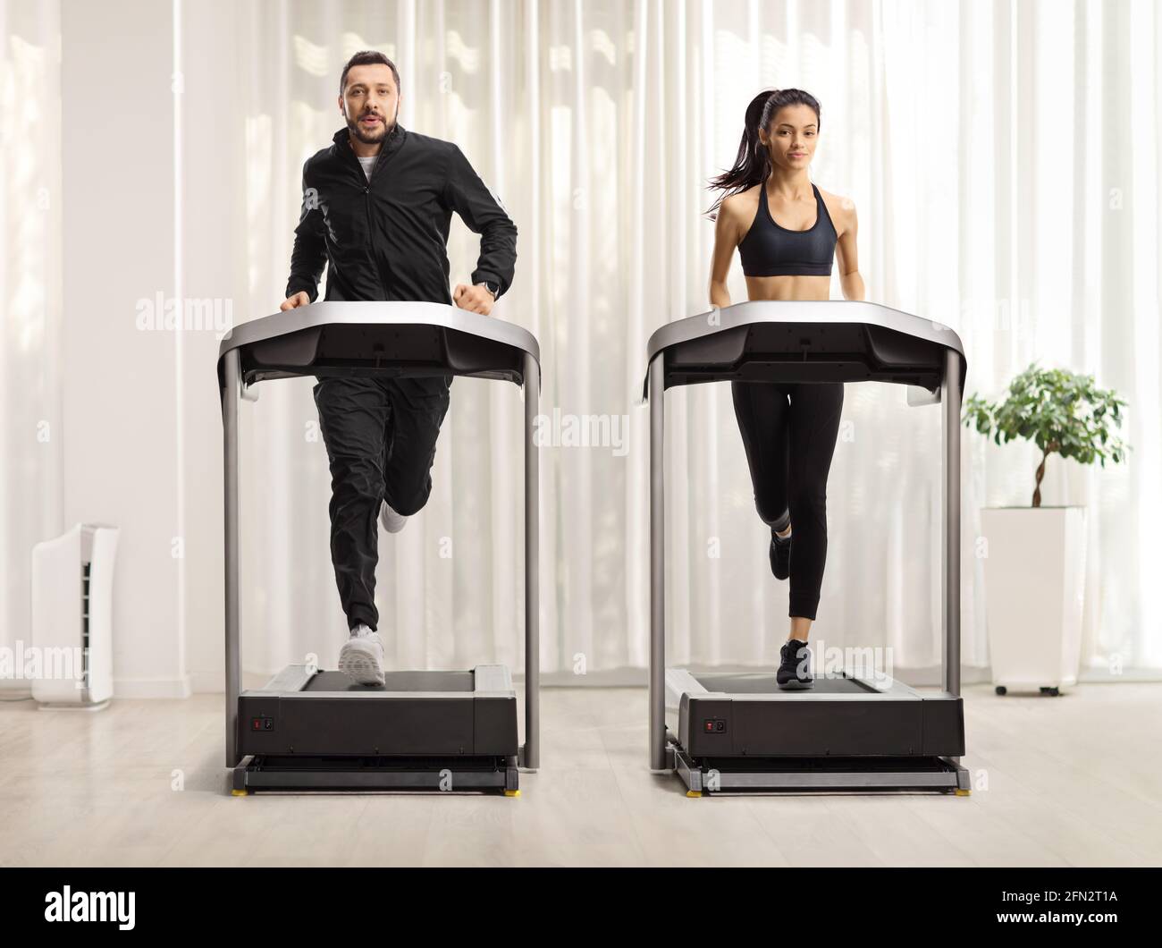 Young man running on treadmill in gym hi-res stock photography and ...