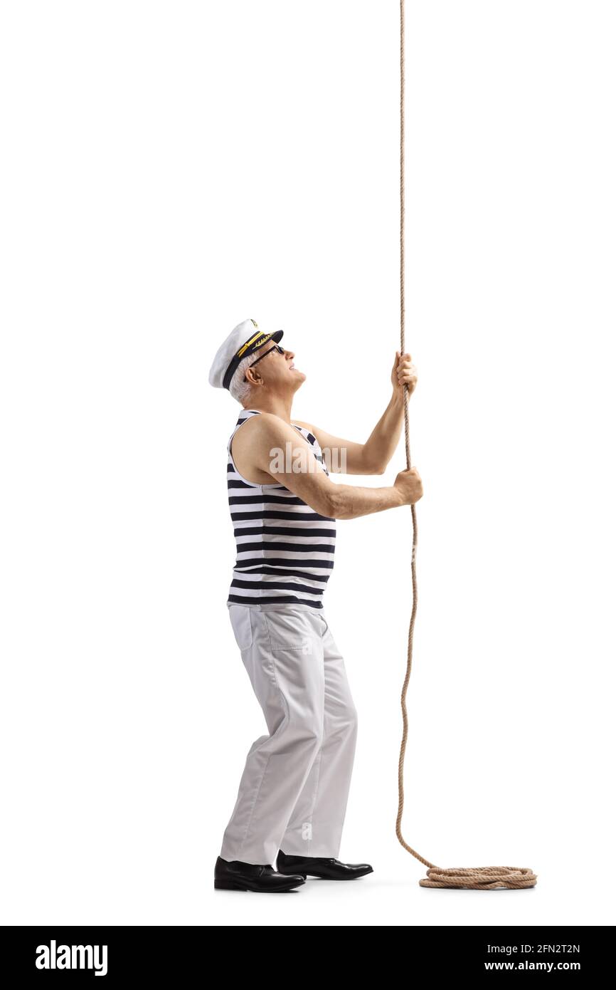 Full length profile shot of a sailor pulling a rope isolated on white ...