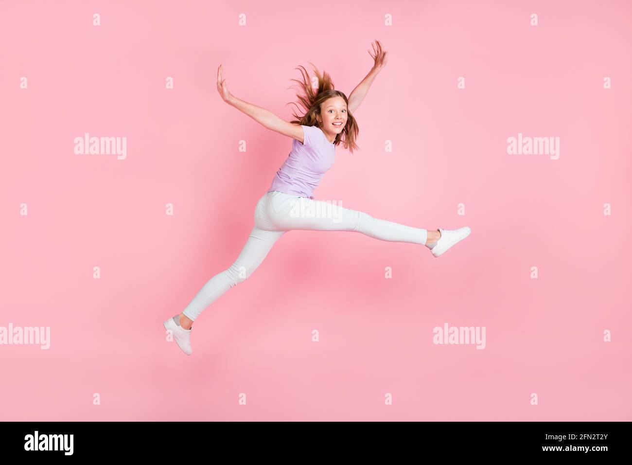 Full length profile side photo of funky little girl jump up raise hands ...