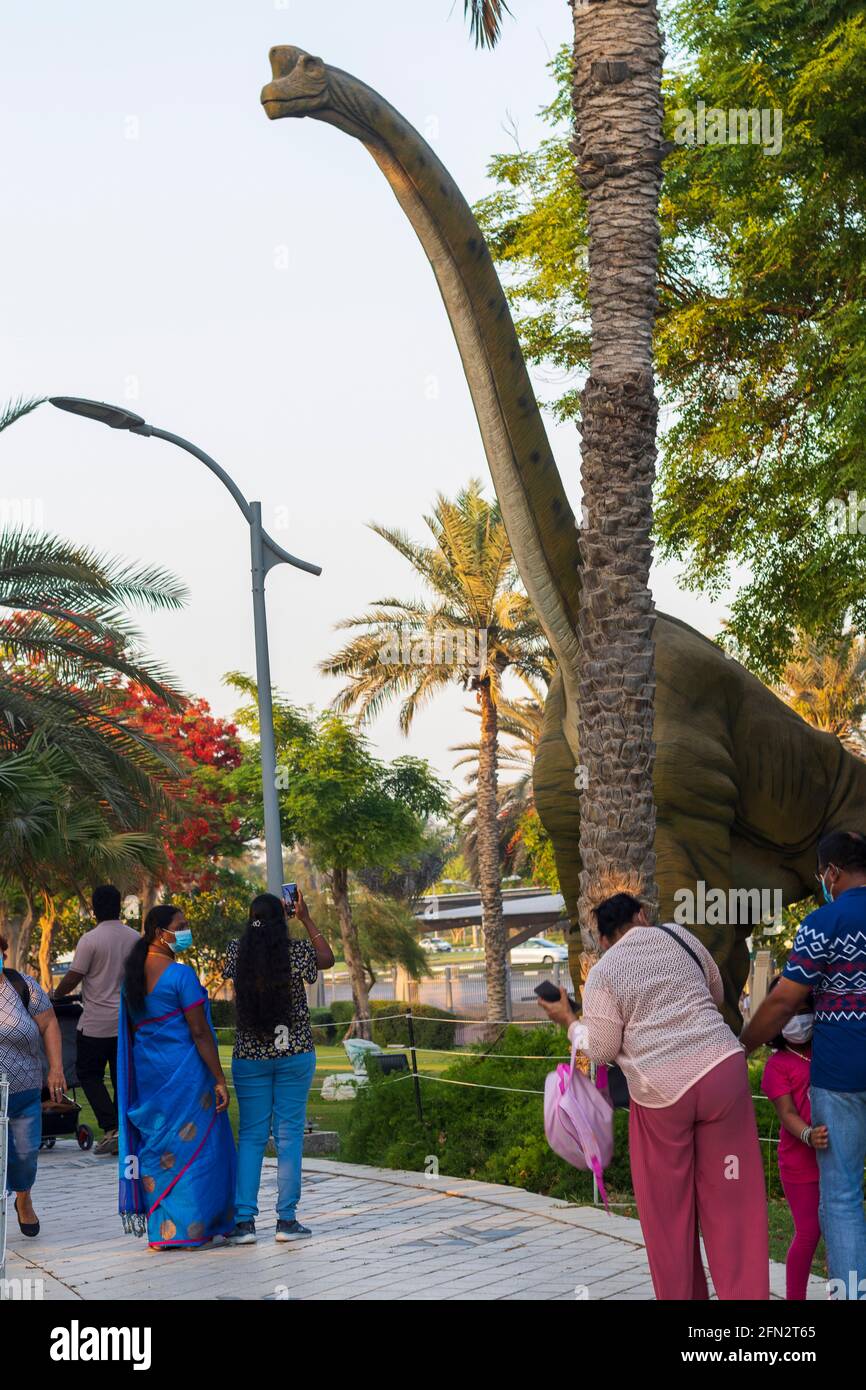 Dubai,UAE - 05.11.2021 -Visitors inspecting austrosaurus replica ...