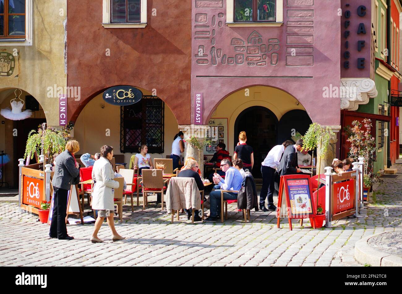 POZNAN, POLAND - Sep 21, 2013: People sitting and drinking at the old ...