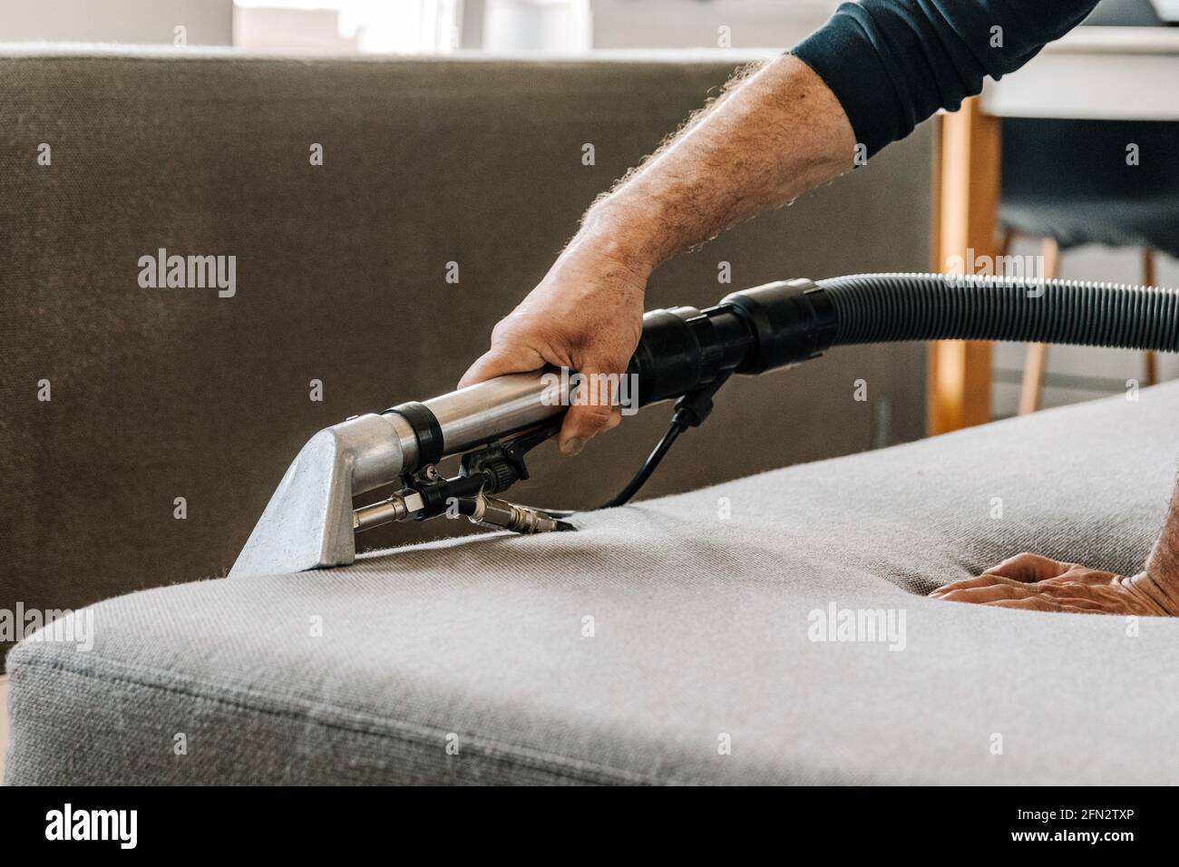 Professional cleaning service deep cleaning sofa at home Stock Photo ...