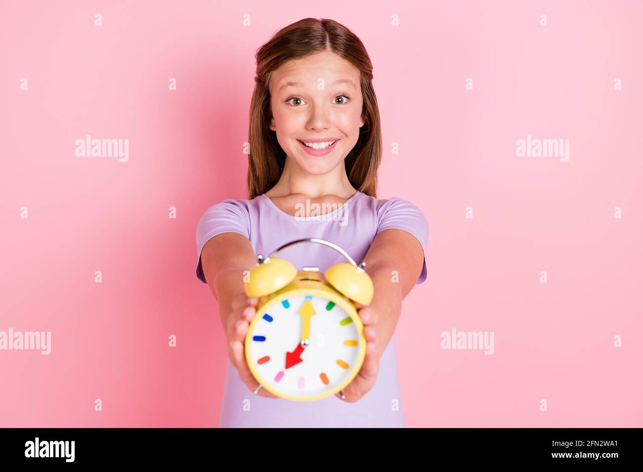 Photo of cute charming little girl hold hands clock give you time ...