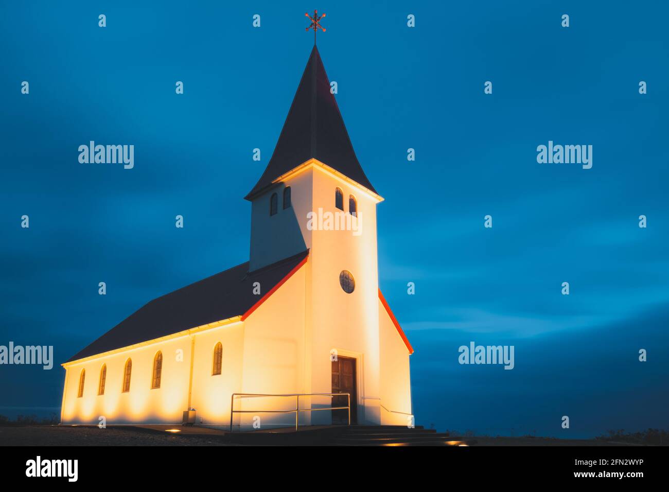 Evening close-up view of an illuminated Reyniskyrka Church at night, a ...