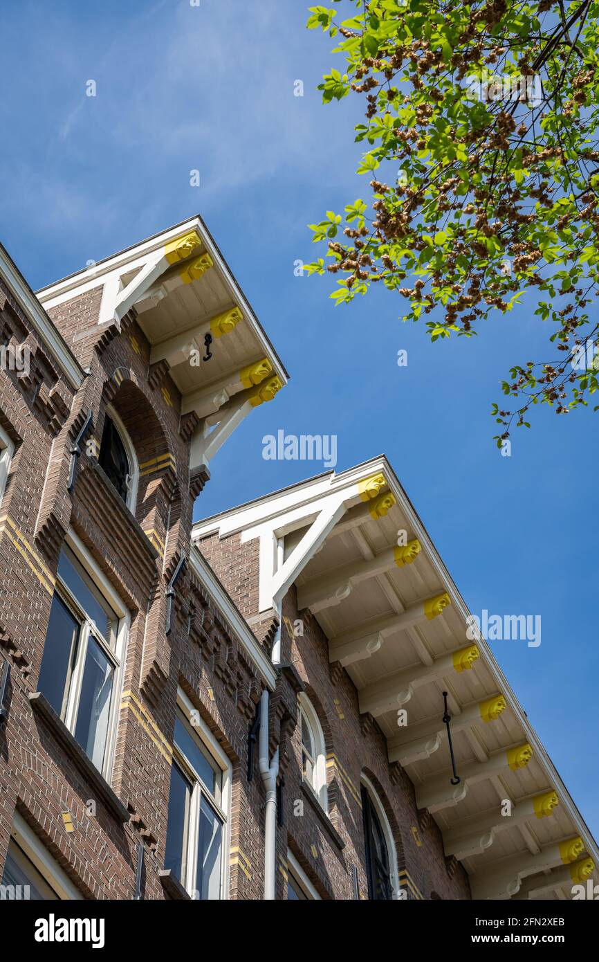 Authentic facade of a Dutch house in Amsterdam with yellow and white ...
