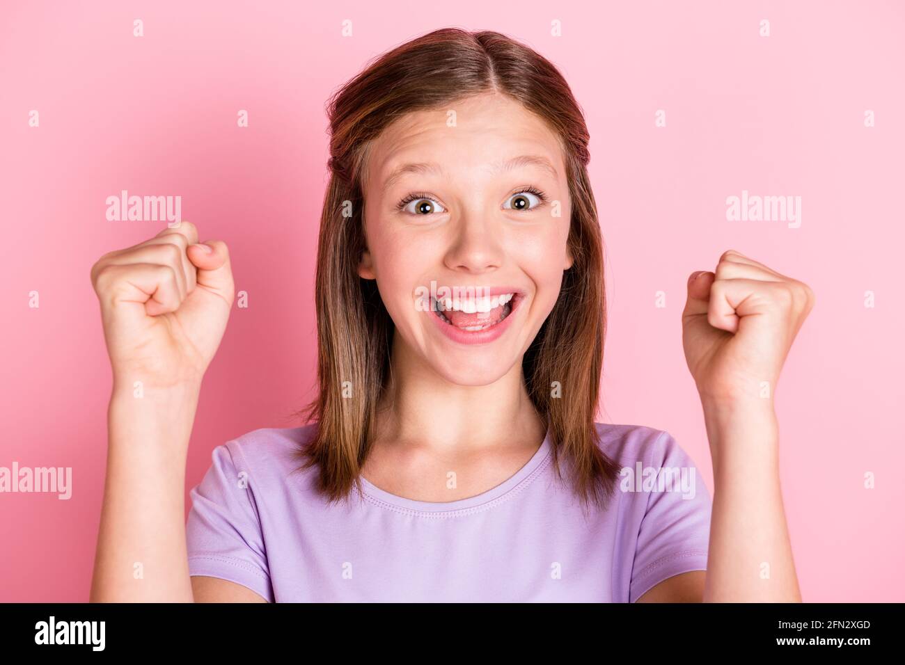 Photo of cheerful happy charming small girl raise fists winner good ...
