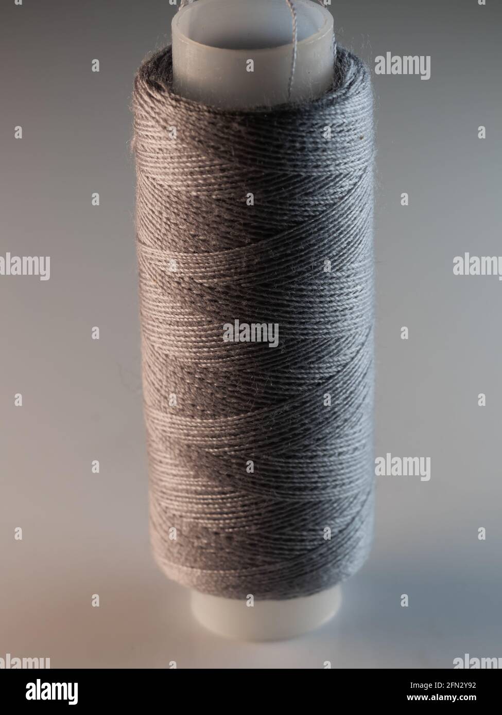 Vertical shot of a gray sewing thread Stock Photo - Alamy