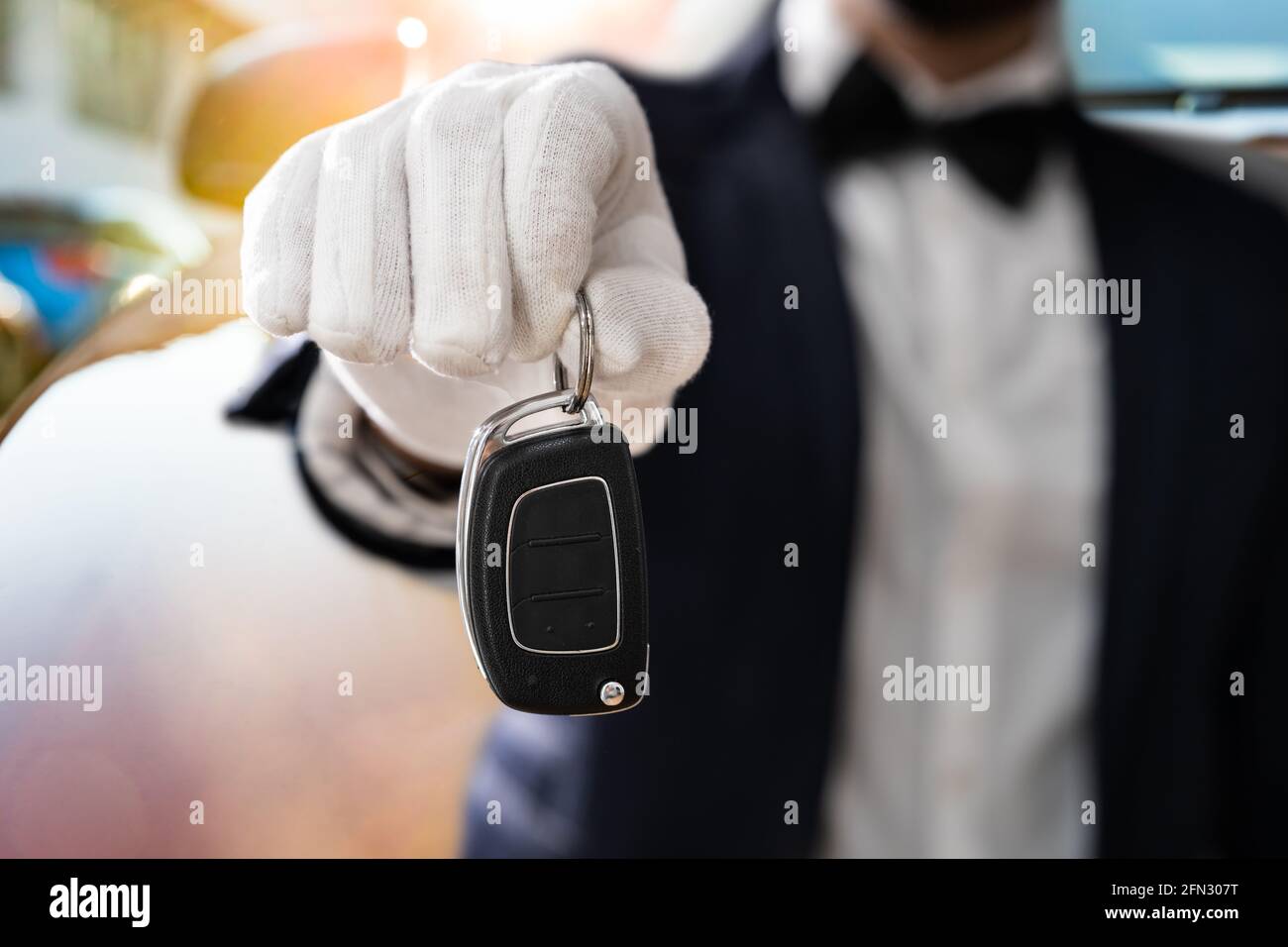 Valet Boy Holding A Car Key Outside The Car Stock Photo - Alamy
