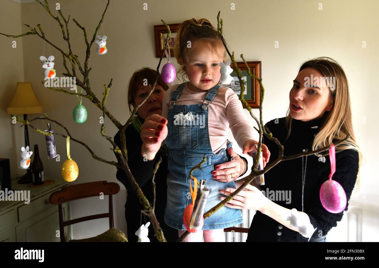 Family celebrating Easter with egg tree Britain Uk Stock Photo - Alamy
