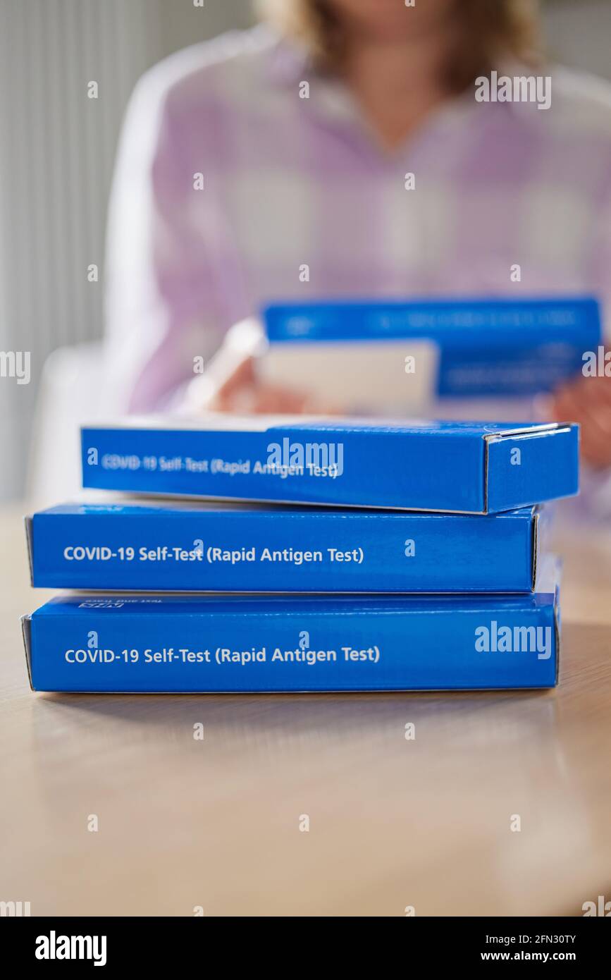 Close Up Of Woman At Home Reading Instructions On Supply Of Covid-19 ...