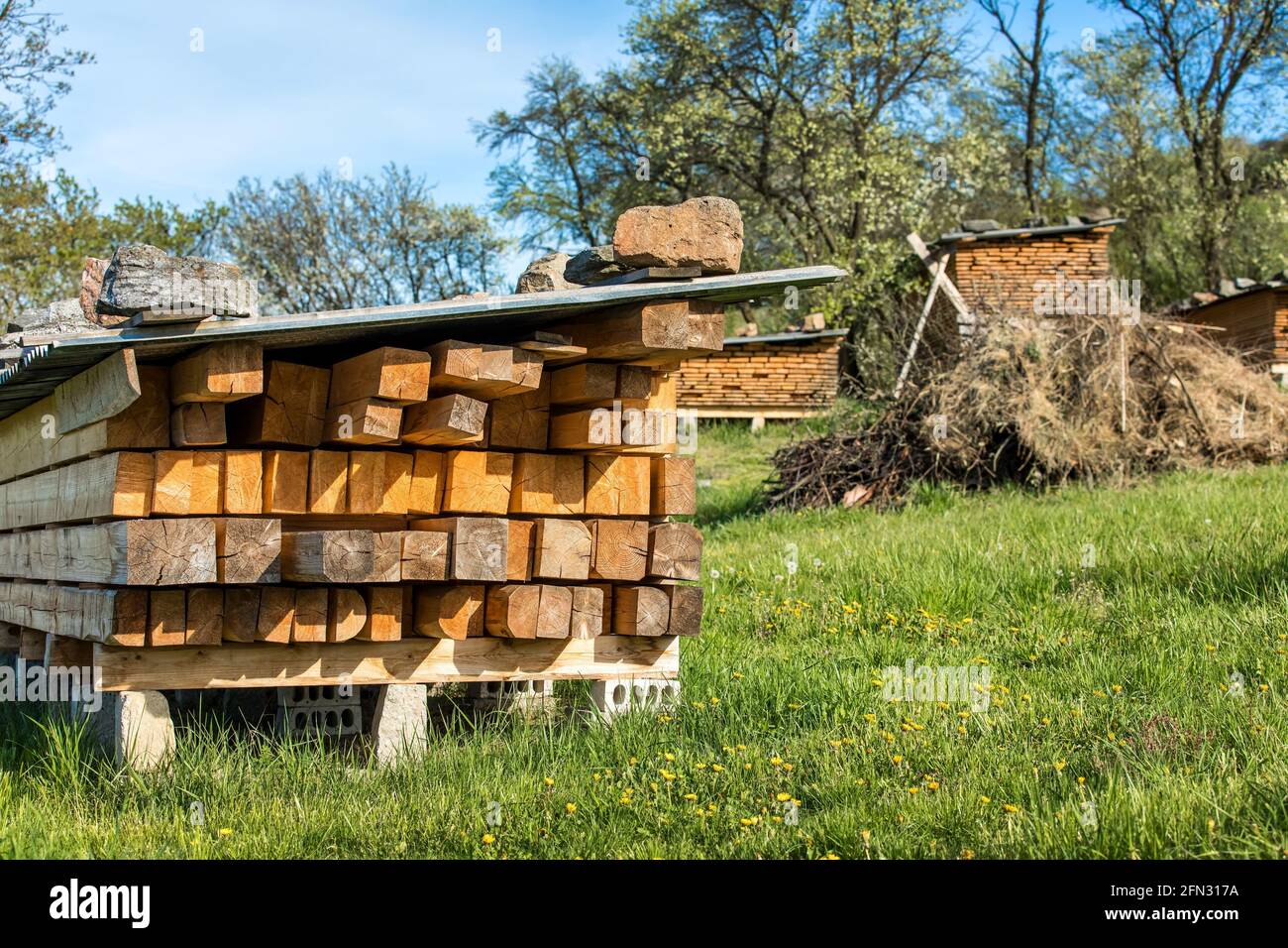 Raw wood under cover in the fresh air dries naturally. Wooden planks ...